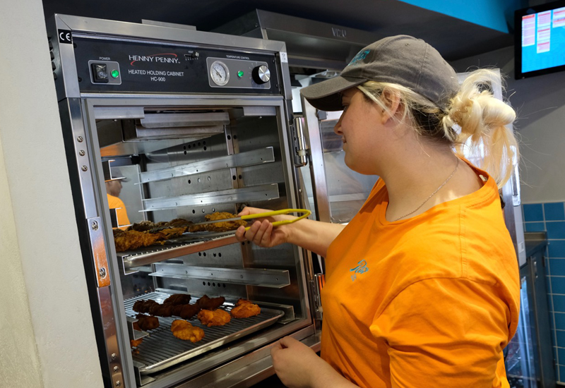 Where does hot holding equipment fit into a modern catering estate?